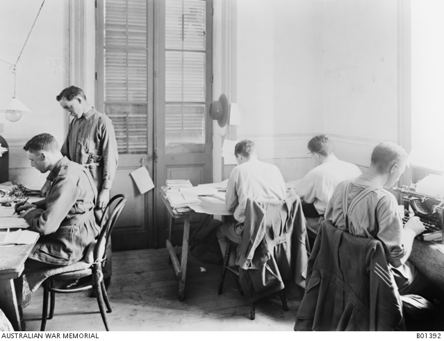 Five men working in the War Records Office. Three identified are ...