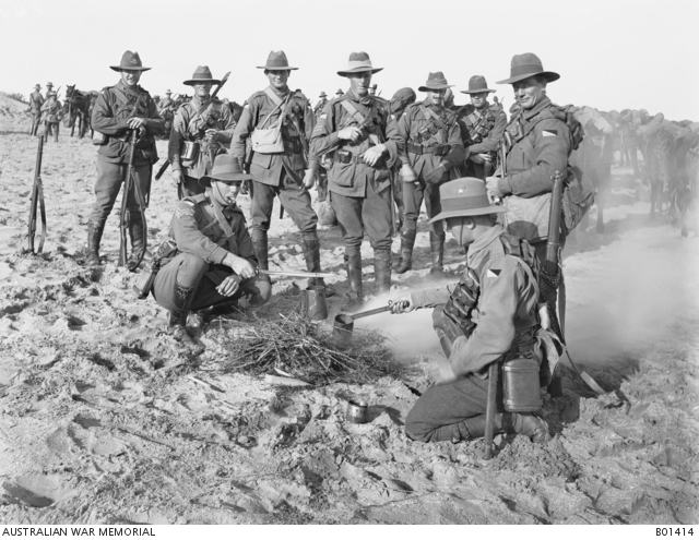 Members of the 3rd Australian Light Horse Regiment "boiling the billy" on the desert sand after ...