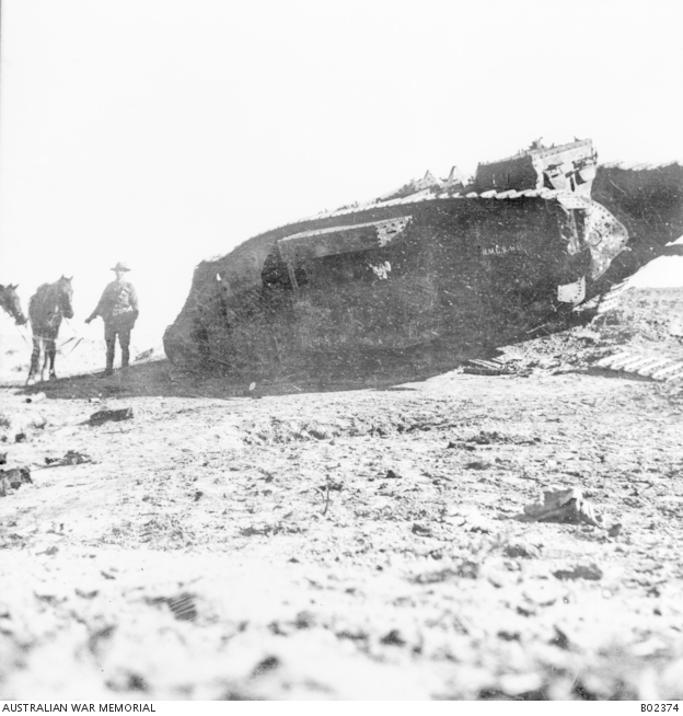 An unidentified soldier standing next to the first tank which was used ...