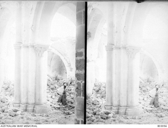 Interior view of a damaged mosque. A local man (right) is standing ...