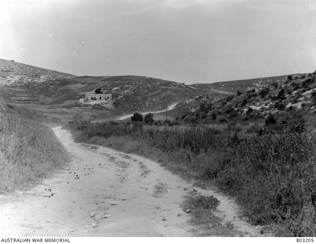 Looking north along Mus Mus Pass. A local man is leading five camels at ...