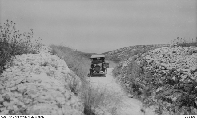 A Model T Ford travelling on the road through Mus Mus Pass. A light has ...