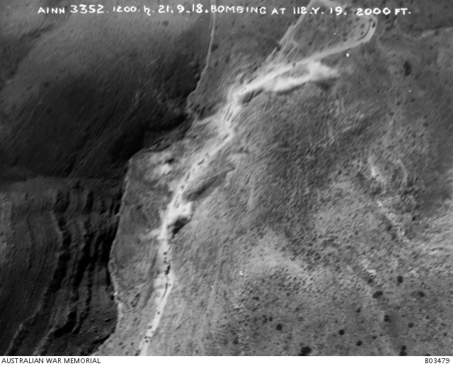 Aerial photograph of bombs exploding next to the road at 112 Y 19 taken ...