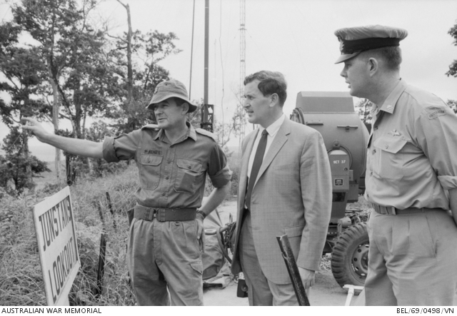 Nui Dat, South Vietnam. 1969-07. Visiting Senator, Peter Rae, receives ...