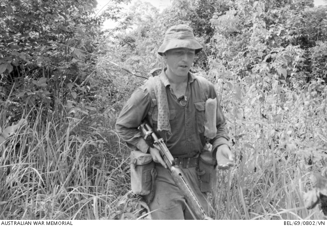 Armed with an M16 automatic rifle and carrying a radio, Corporal (Cpl ...