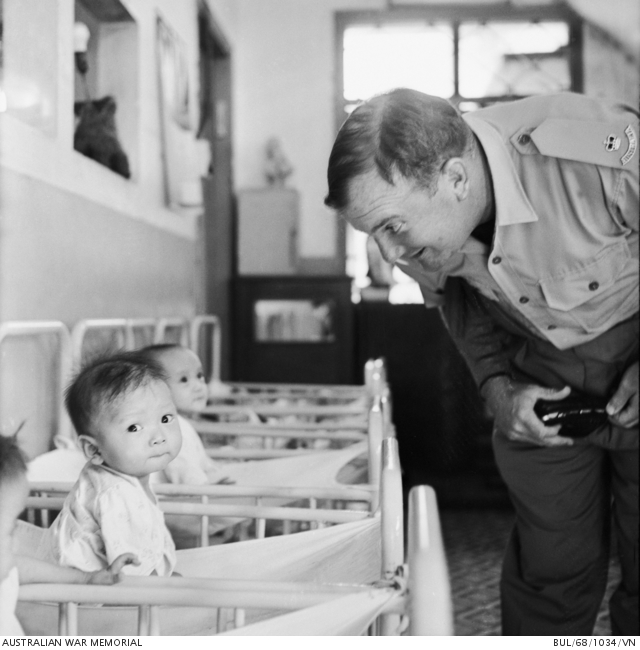 Major Cliff Dodds of Willoughby, NSW (right), about to give this young ...