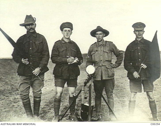 Group portrait of four unidentified signallers. The men on the far left ...