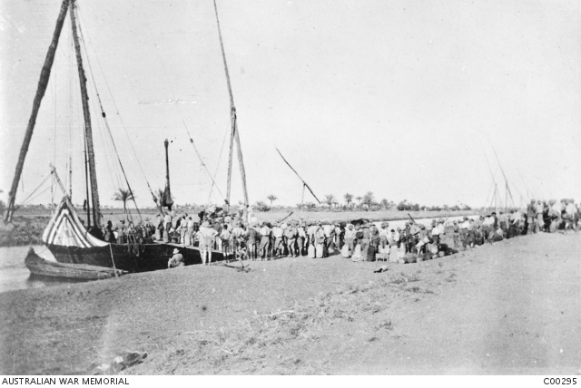 Members of the 52nd Battalion queue beside the Sweet Water Canal to ...
