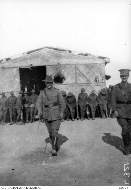 A group of members of the 21st Battalion prepare to lift a mess hut and ...