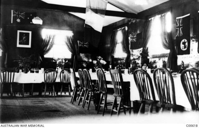 Tables set for a meal in the officers' mess room at Hurdcott Camp near ...