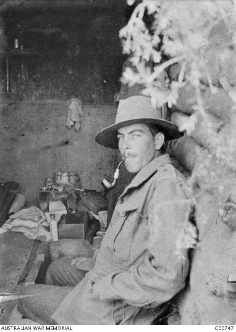 An unidentified Australian officer smoking a pipe inside his dugout on ...