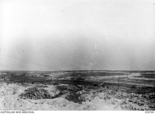 A panorama of an old Somme battlefield. A large shell hole is visible ...