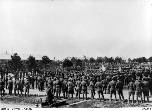 Crowds of soldiers and officers watch a boxing competition at an ...