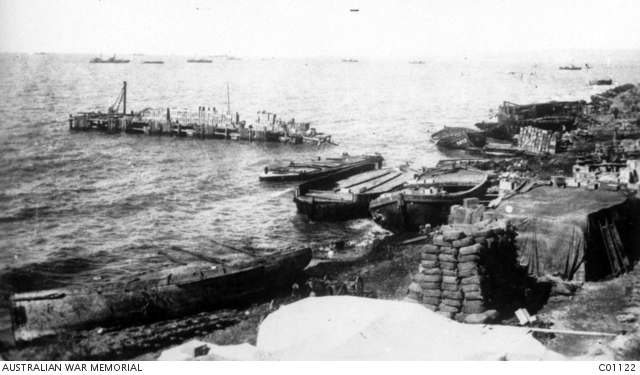 The impact of a heavy storm on Anzac Beach. Behind the three barges in ...