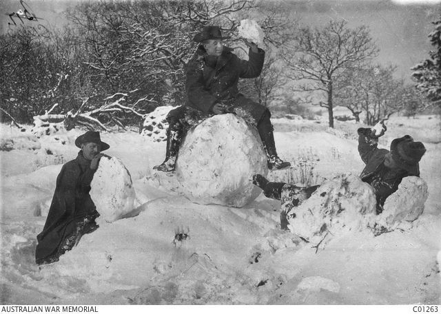 Three unidentified soldiers enjoy the snow at a camp in Wiltshire ...