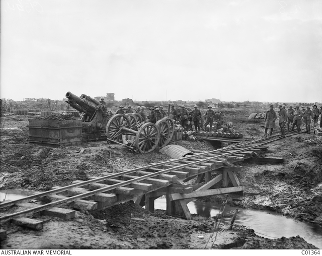 A gun crew operating a 9.2 inch howitzer. Shells are lined up for ...