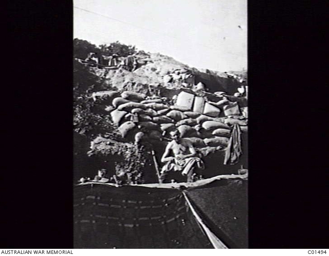An unidentified soldier delouses his clothes in the reserve trenches in ...