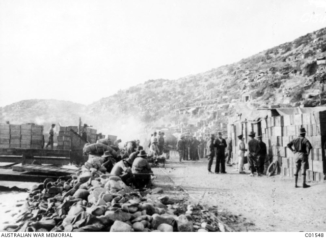 A typical busy scene on the beach at Anzac Cove. On the right is the ...