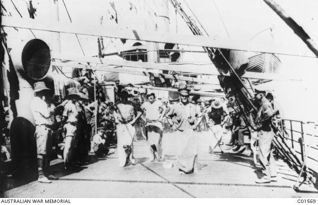 Troops aboard the transport ship SS Port Nicholson watch some of their ...