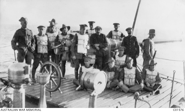 Group portrait of unidentified members of a gun crew and a Royal Marine ...