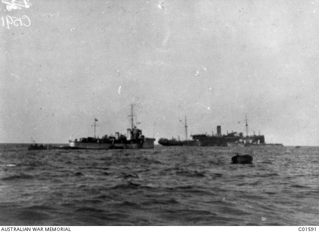 A destroyer rescuing men from the transport ship HMAT Ballarat. The ...