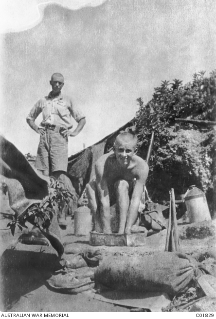 An unidentified soldier has a monthly bath in a pint of water while ...