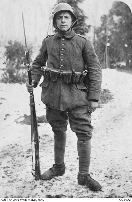 Portrait of an unidentified German sniper wearing a tin helmet. The ...