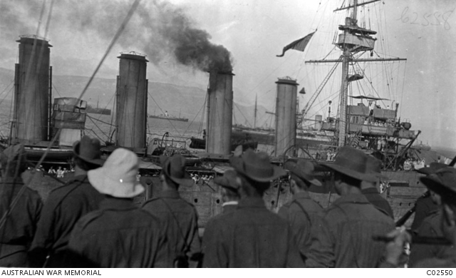 Soldiers mustered on the deck of HMAT Omrah (A5) watch as the ships of ...