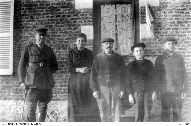Chaplain Ernest Northcroft Merrington (far left) and a French family ...