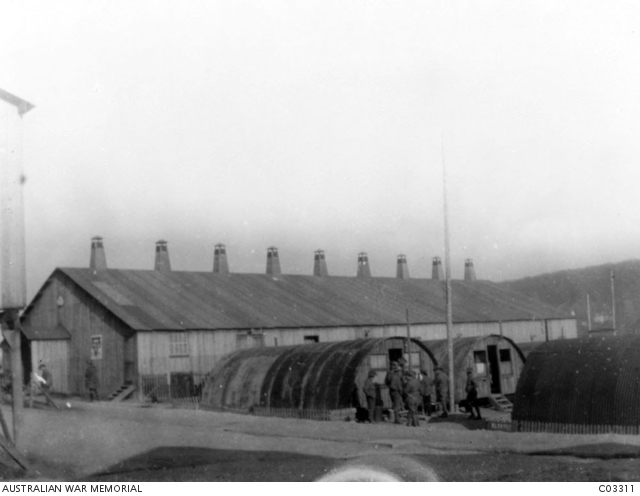 Australian soldiers gathered outside the entrance of an igloo, a semi ...