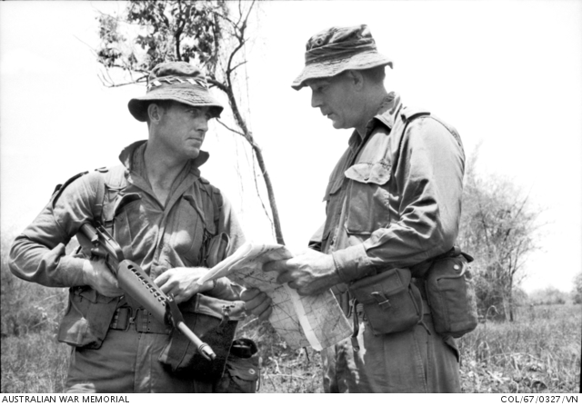 Nui Dat, Vietnam. 1967. Surveying a map on the tactical situation ...