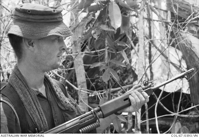 Vietnam. 1967-05. A rice cache hut is checked by Private Justin Jordan ...