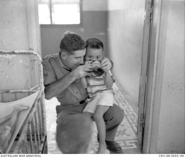 Staff Sergeant (SSgt) Rod Painter of Bayswater, WA, helps a young ...