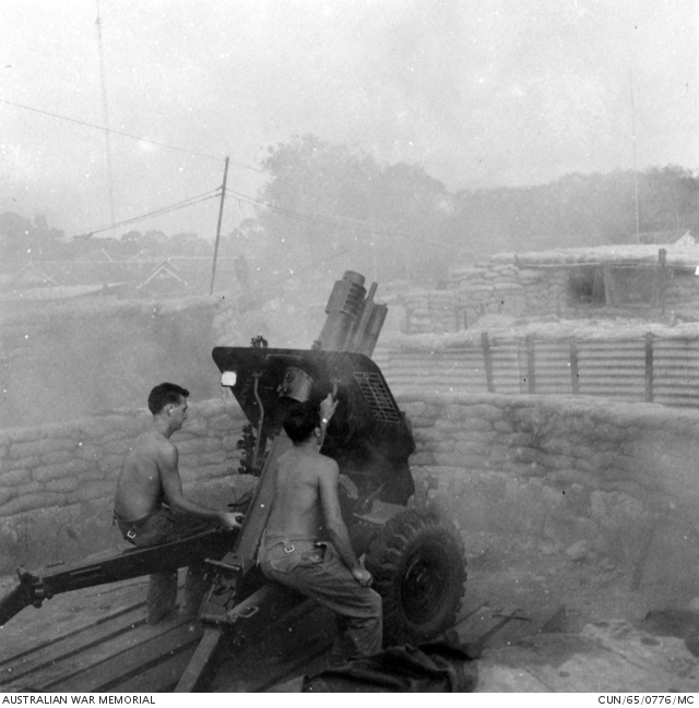 In the half light of dawn, with their 105mm L5 Pack Howitzer fully ...