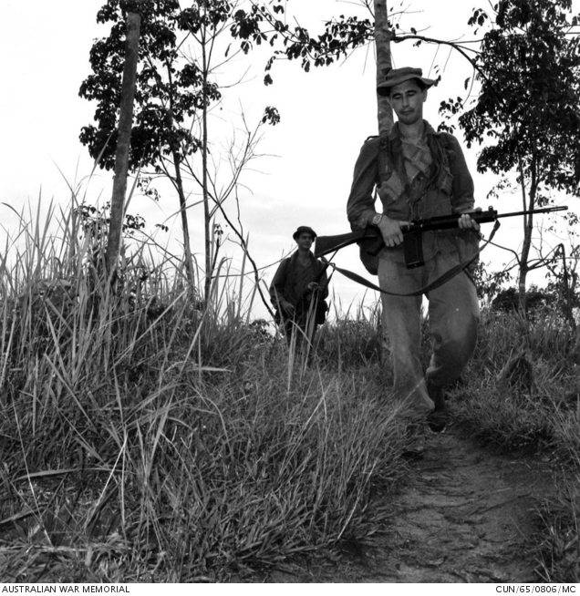 Armed with an L1A1 self loading rifle (SLR), and followed by an ...