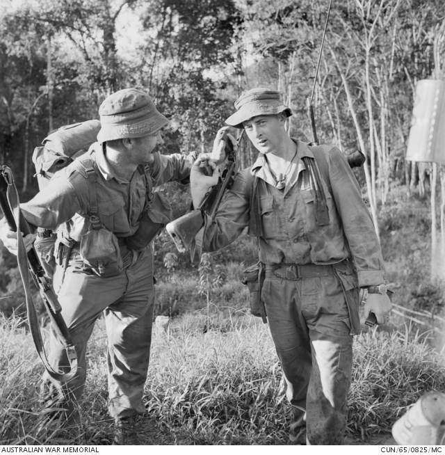 Sergeant Hugh Cross (left), of Corinda, Qld, checks that the Owen ...