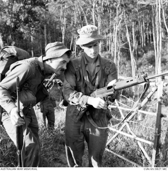 Sergeant Hugh Cross (left), of Corinda, Qld, checks that the L1A1 self ...