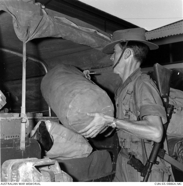 With an Owen machine carbine slung over his shoulder, 37140 Gunner (Gnr ...