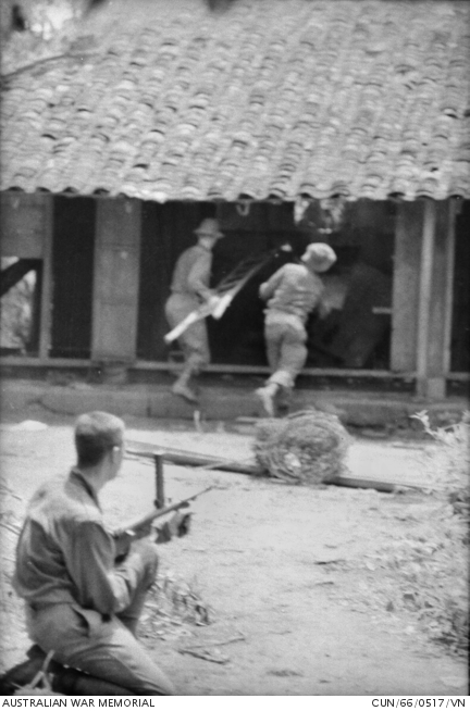 Troops of the 6th Battalion, The Royal Australian Regiment (6RAR), move ...