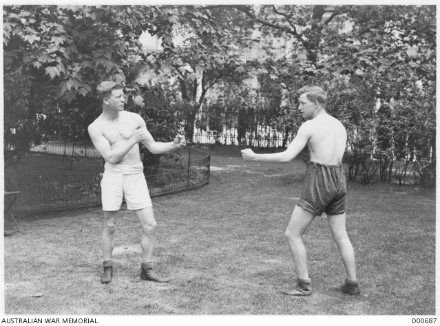 Outdoor portrait of two boxers striking a boxing pose. Identified on ...