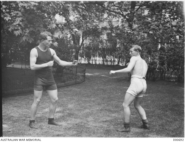 Outdoor portrait of two boxers striking a boxing pose. Identified on ...