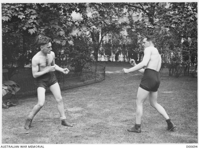 Outdoor portrait of two boxers striking a boxing pose. Identified on ...