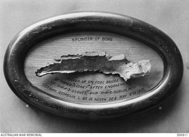 Display of a mounted splinter of bomb picked up on the forebridge of ...