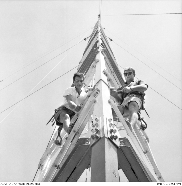 Ban Me Thuot, Vietnam. 1965-08. Australian riggers working up high on a ...
