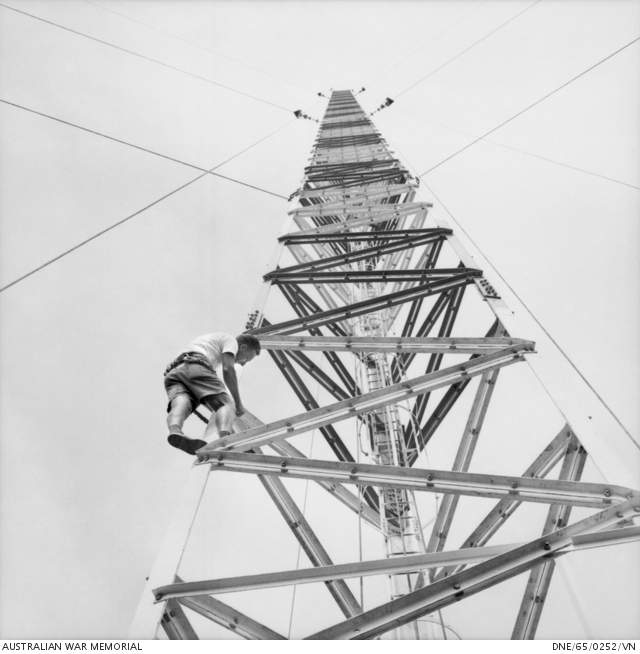 Ban Me Thuot, Vietnam. 1965-08. An Australian rigger working up high on ...