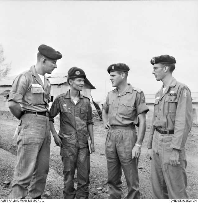 Discussing training methods at the Tra Bong Training Camp. Left to ...