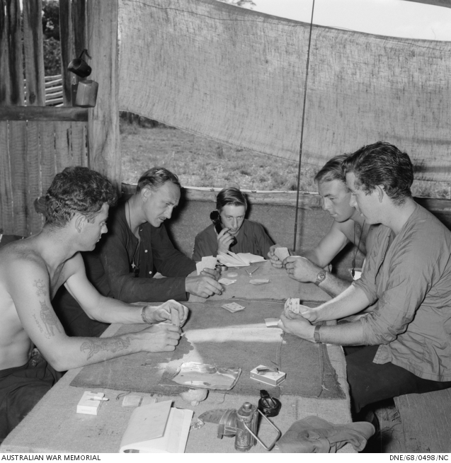 A game of cards passes the time for these "villagers", left to right ...