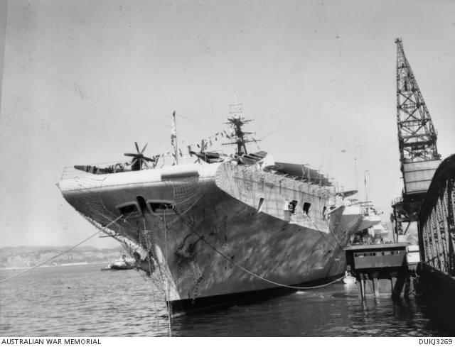 The aircraft carrier HMS Triumph visits a Japanese base, probably in ...