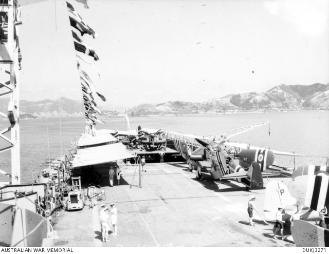 The aircraft carrier HMS Triumph visits a Japanese base, probably in ...