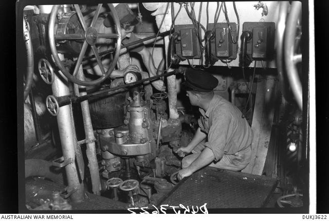 Two unidentified crew members of the RAN destroyer HMAS Bataan, carry ...